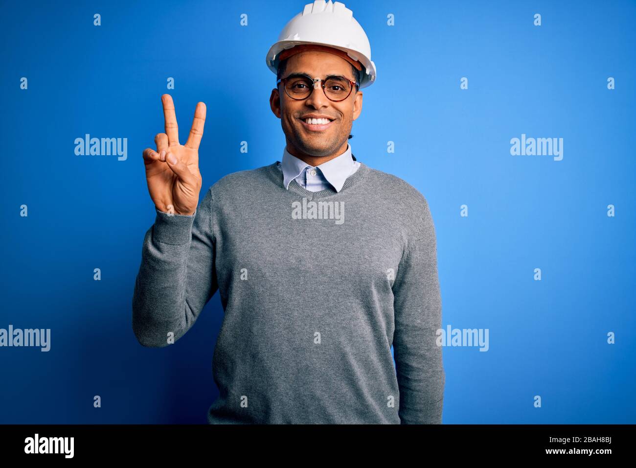 Young handsome african american engineer man with dreadlocks wearing ...