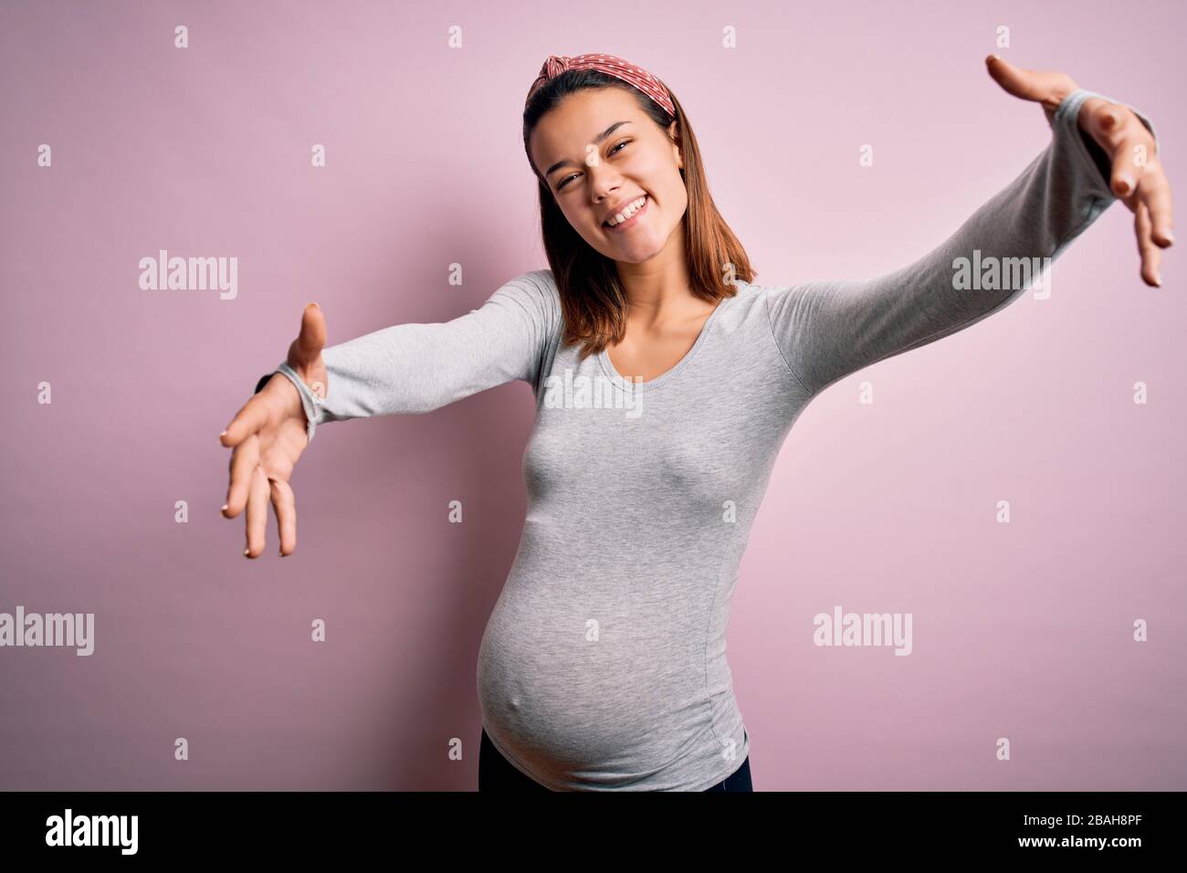 Young beautiful teenager girl pregnant expecting baby over isolated ...