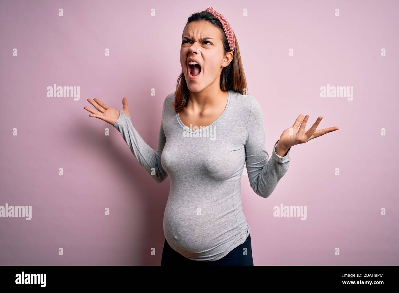 Young beautiful teenager girl pregnant expecting baby over isolated ...