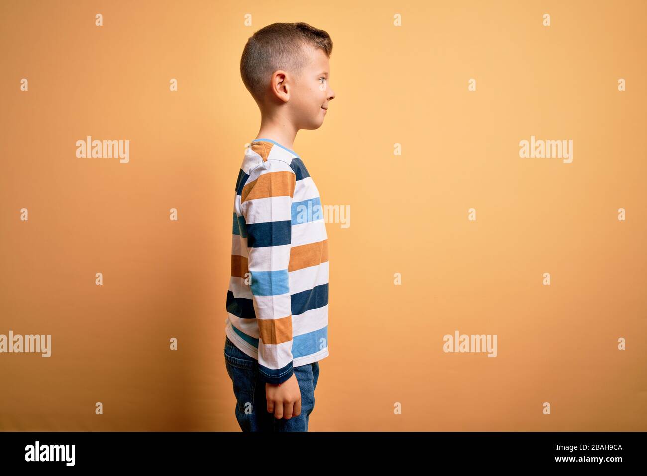 Young little caucasian kid with blue eyes wearing colorful striped ...