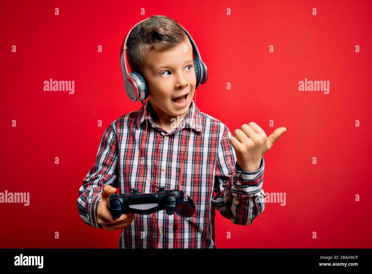 Young little caucasian gamer kid playing video games using gamepad ...