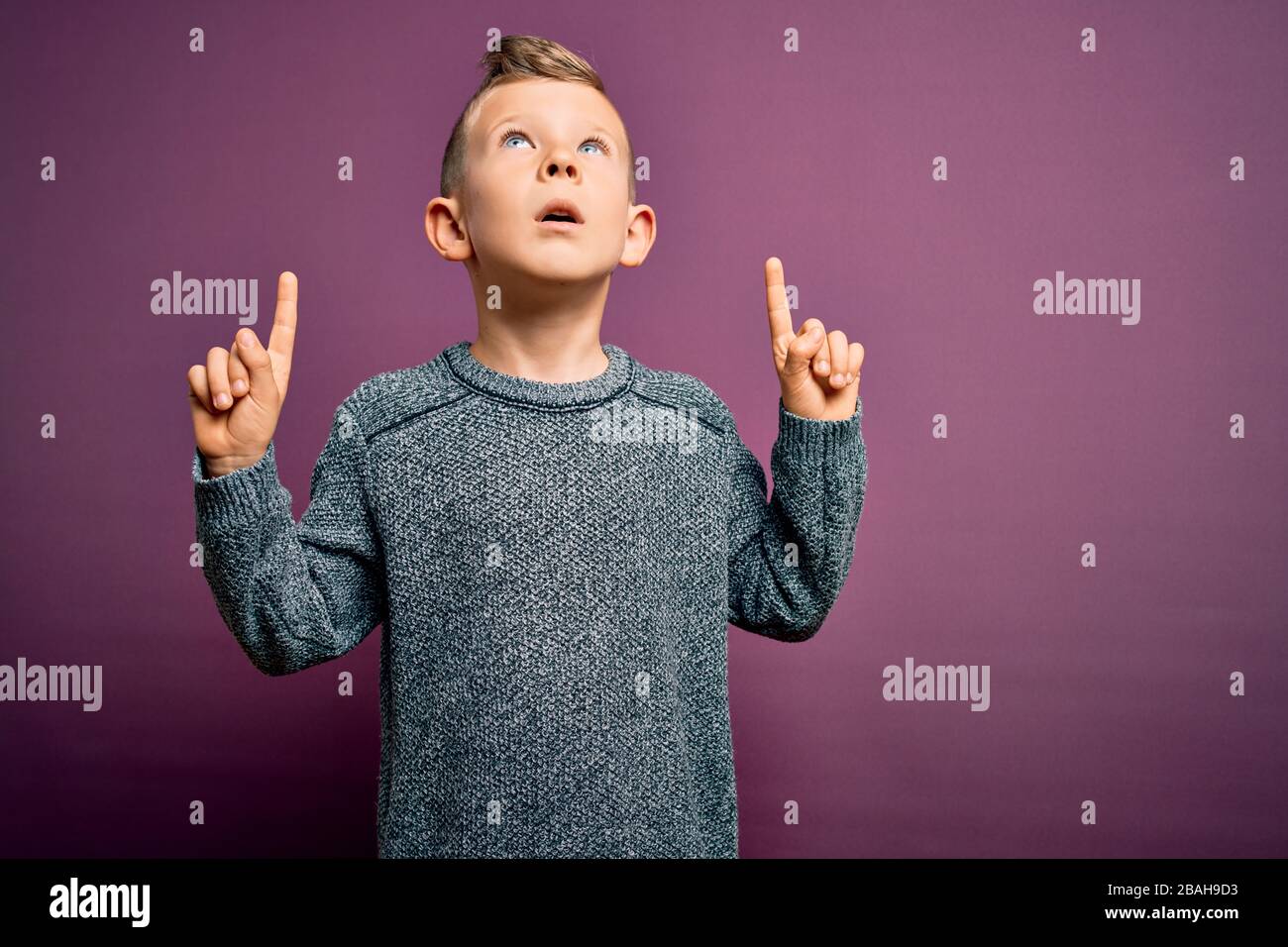 Young little caucasian kid with blue eyes wearing winter sweater ...