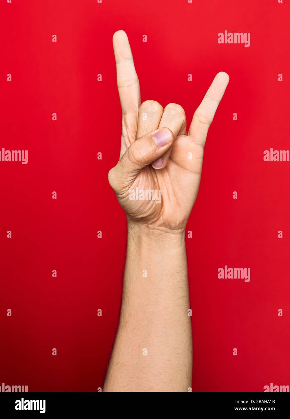Beautiful hand of man doing rock symbol with horns sign Stock Photo - Alamy