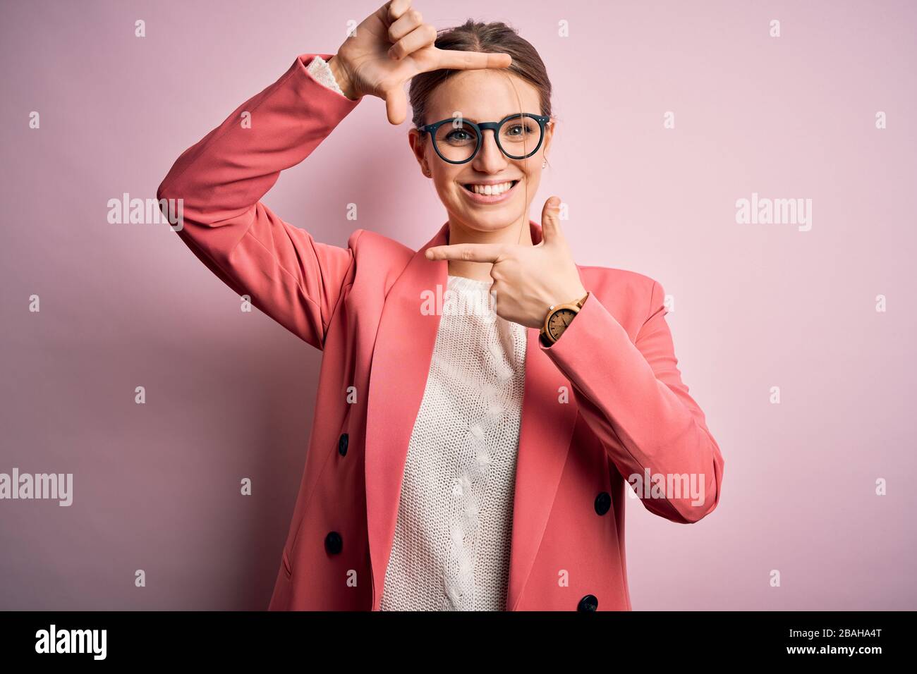 Young beautiful redhead woman wearing jacket and glasses over isolated ...