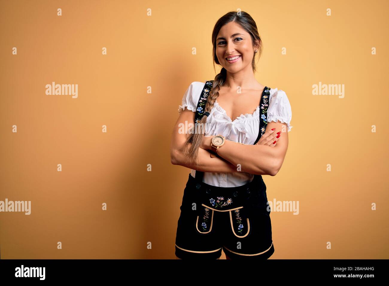 Young beautiful brunette german woman celebrating Octoberfest wearing ...