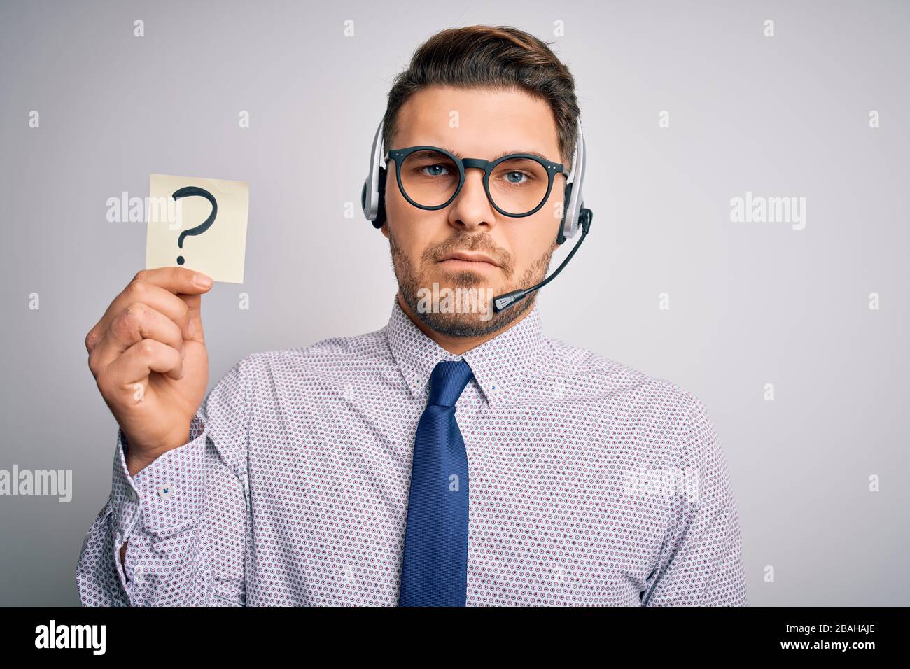 Young call center operator business man with blue eyes holding paper ...