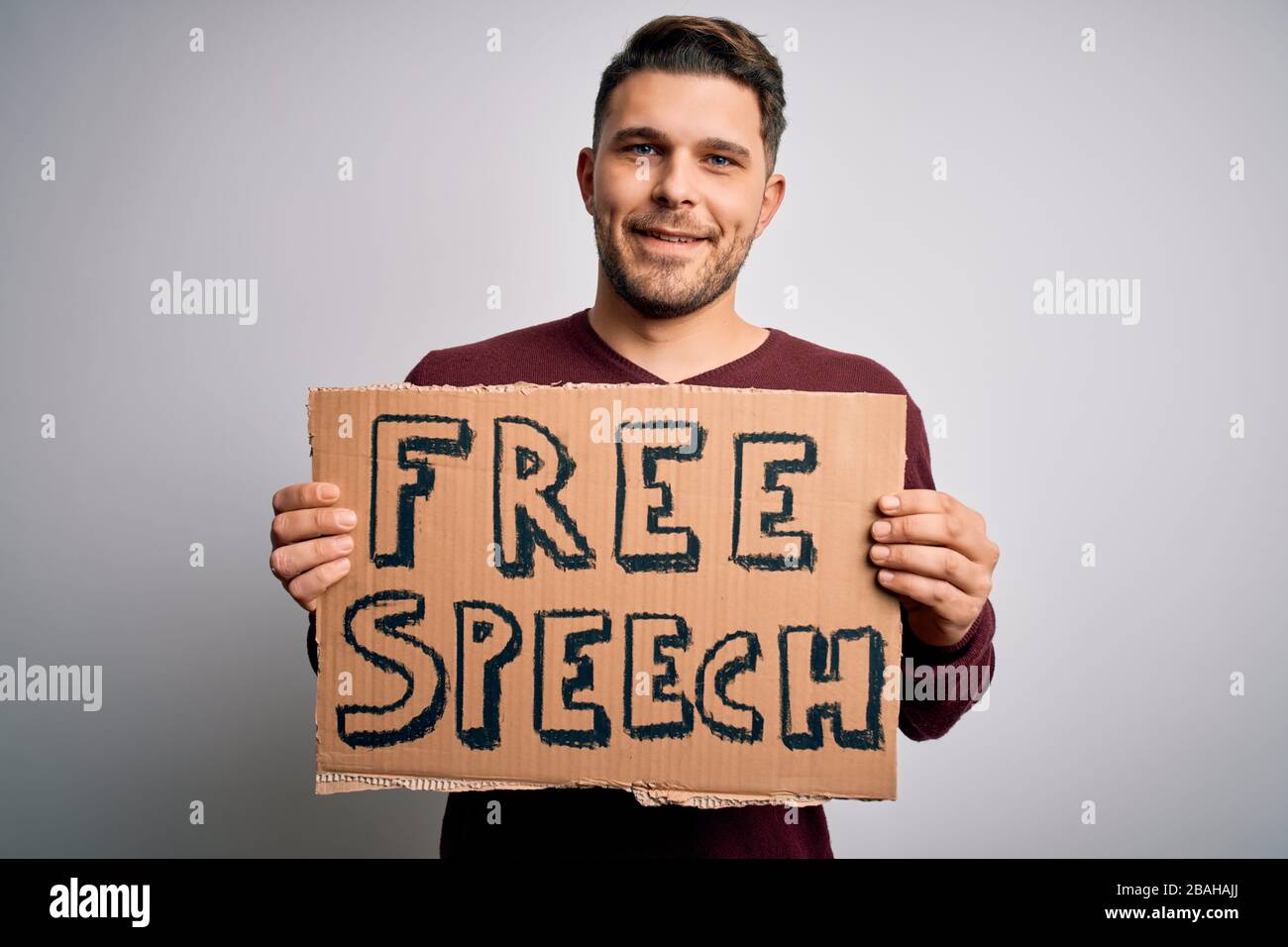Young man with blue eyes holding banner on protest for free speech ...