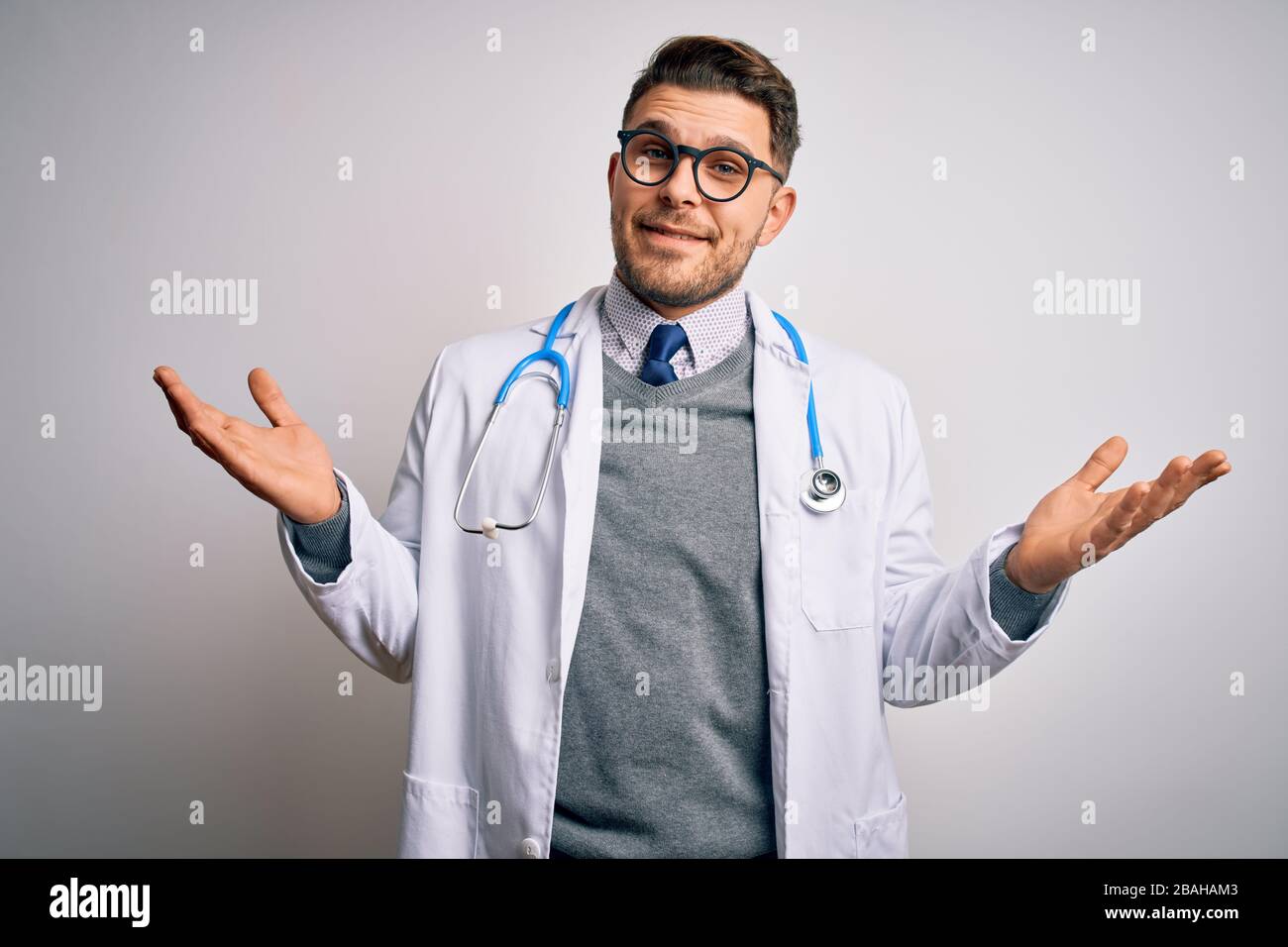 Young doctor man with blue eyes wearing medical coat and stethoscope ...