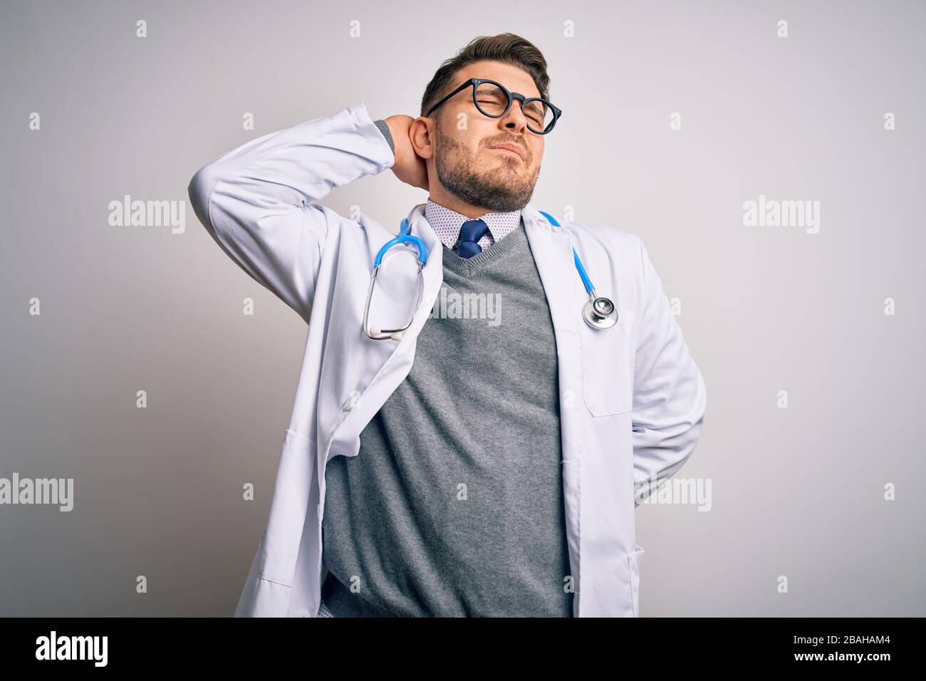 Young doctor man with blue eyes wearing medical coat and stethoscope ...