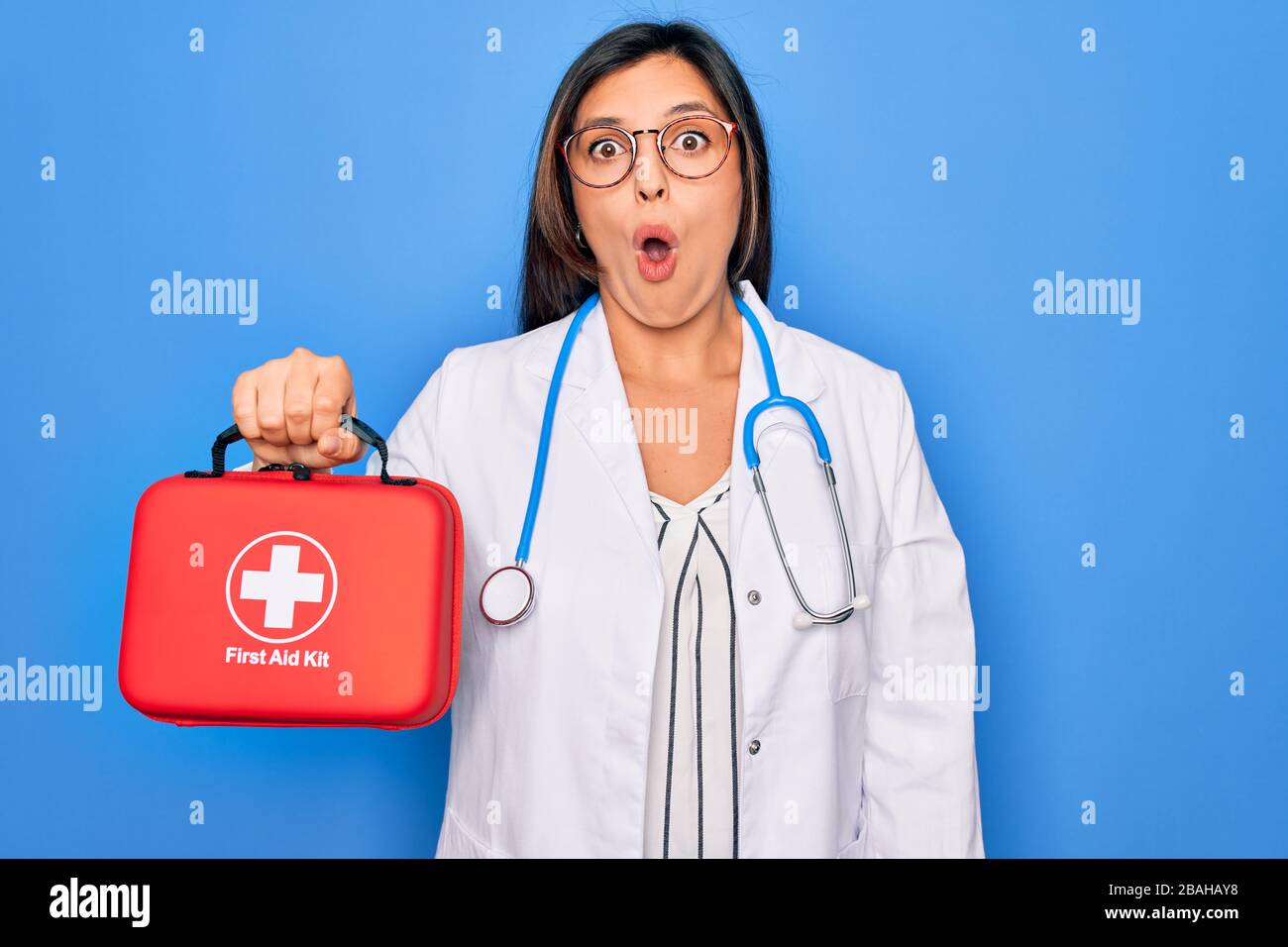 Young doctor woman holding medical first aid kit red box for emergency ...