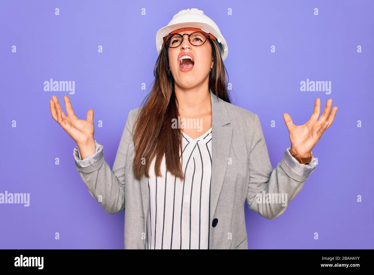 Professional woman engineer wearing industrial safety helmet over ...