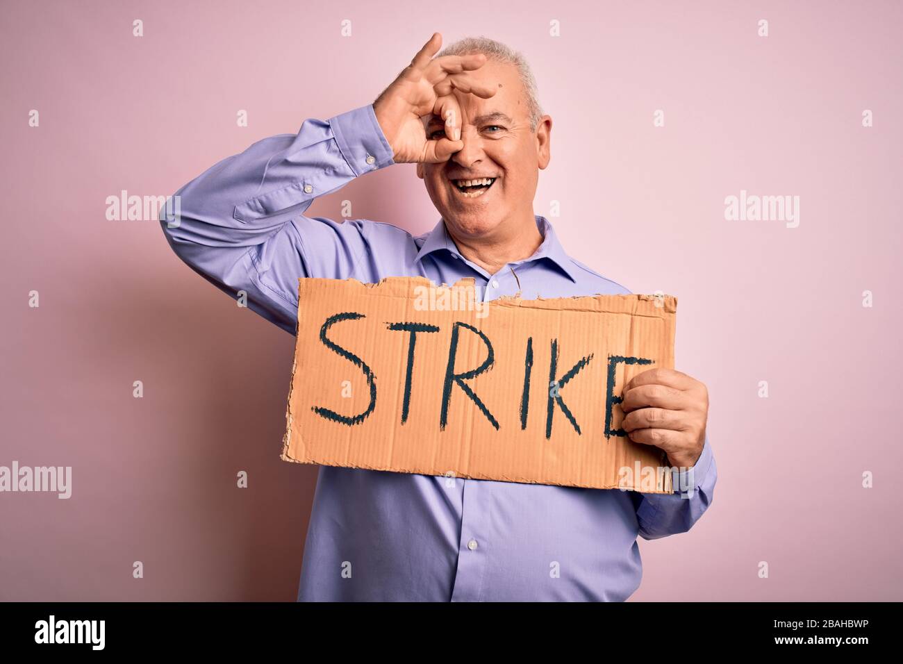 Middle age man asking for rights holding banner with strike message ...