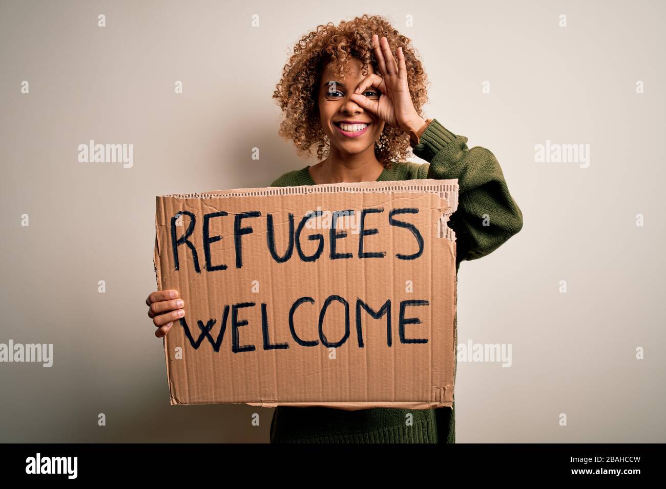 African american woman asking for immigration holding banner with ...