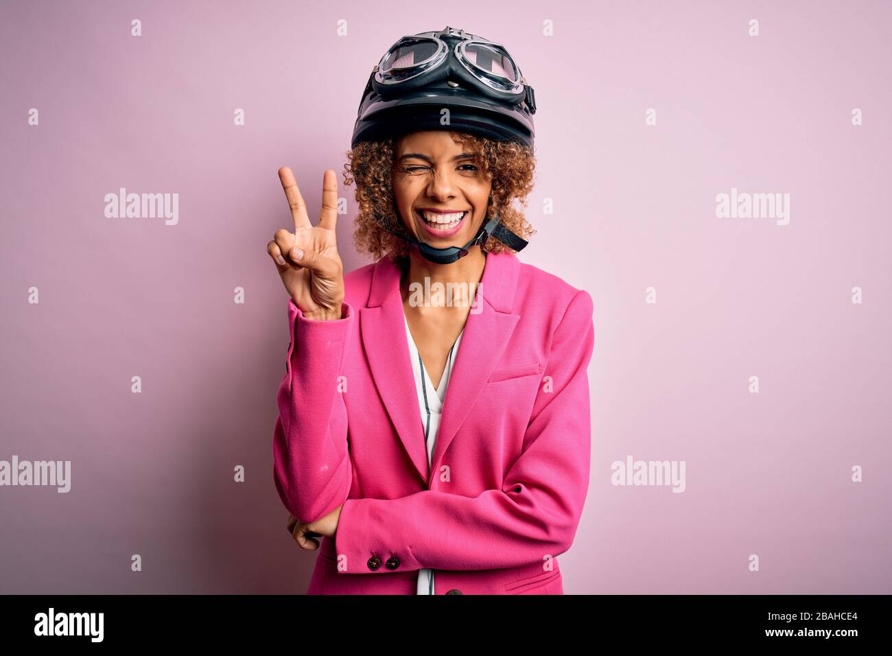 African american motorcyclist woman with curly hair wearing moto helmet ...