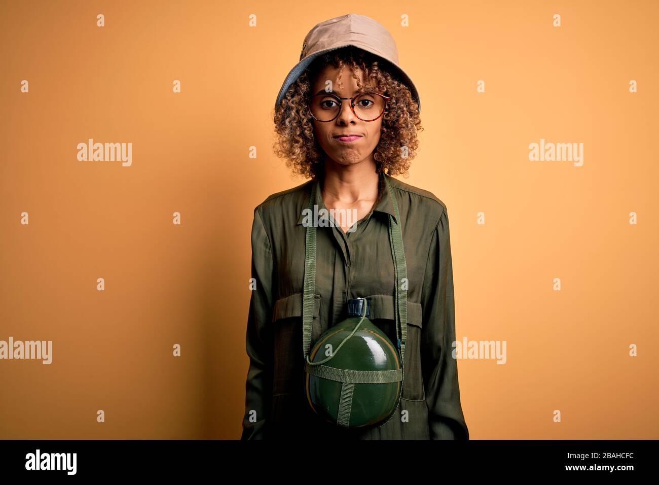 Young african american tourist woman on vacation wearing explorer hat ...
