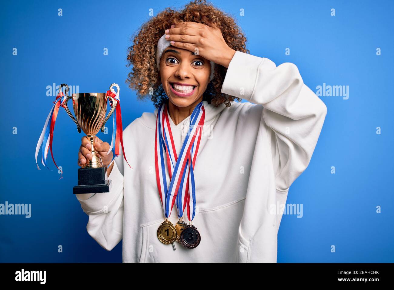 Young african american sporty woman doing sport winning medals and ...