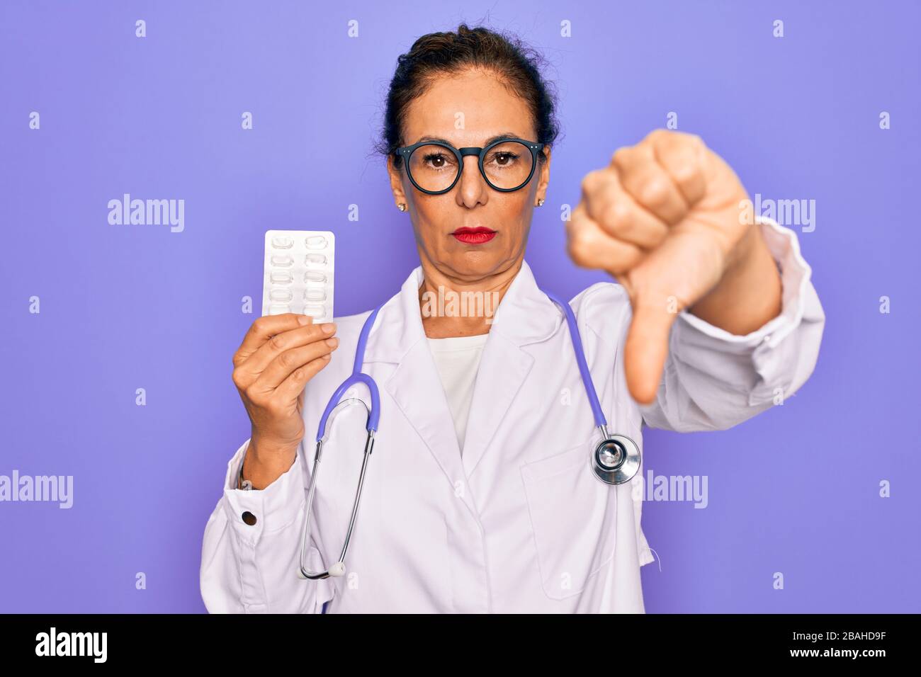 Middle age senior professional doctor woman holding pharmaceutical ...