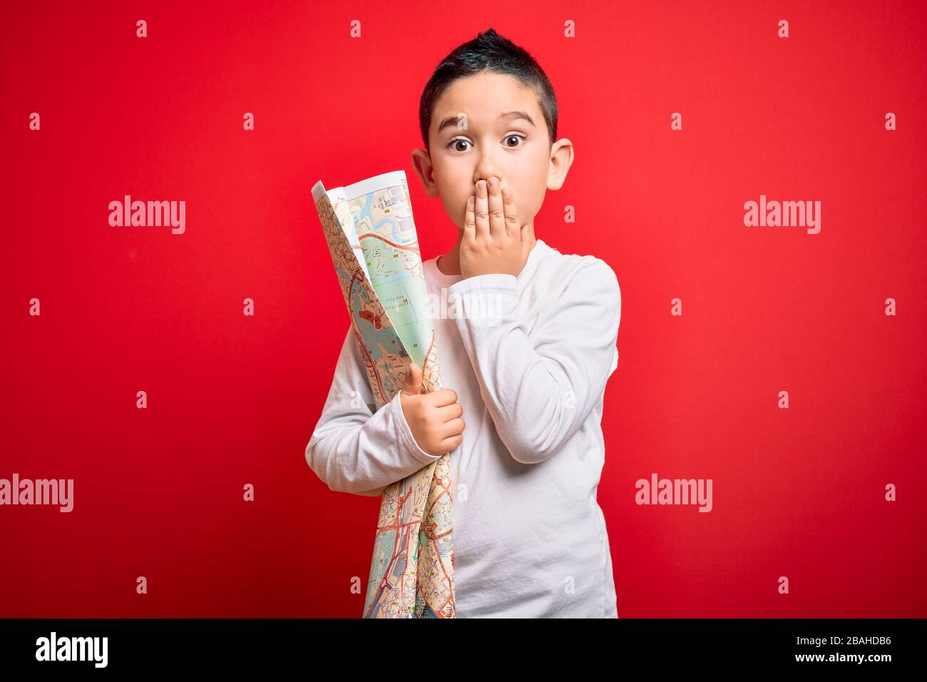 Young little boy kid looking at turist city destination map over red ...