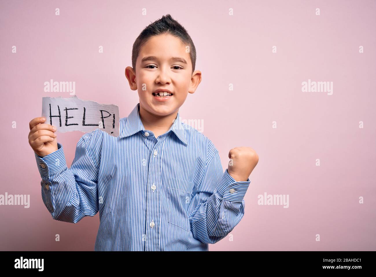Young little boy kid holding paper sing with help message asking for ...