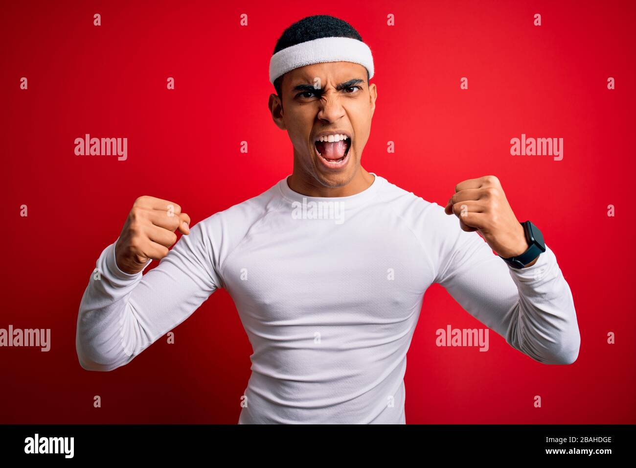Young handsome african american sportsman wearing sportswear over red ...