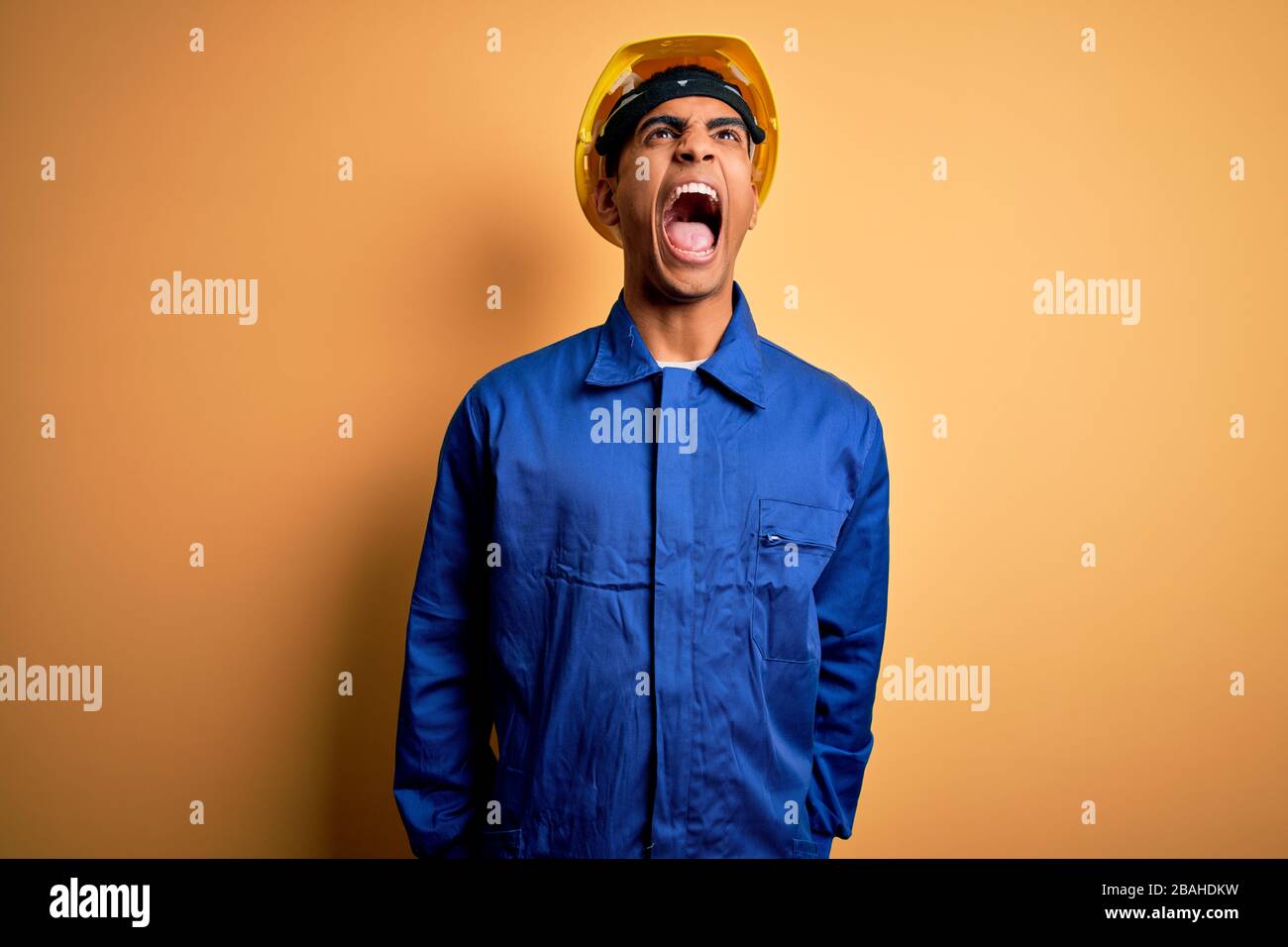 Young handsome african american worker man wearing blue uniform and ...