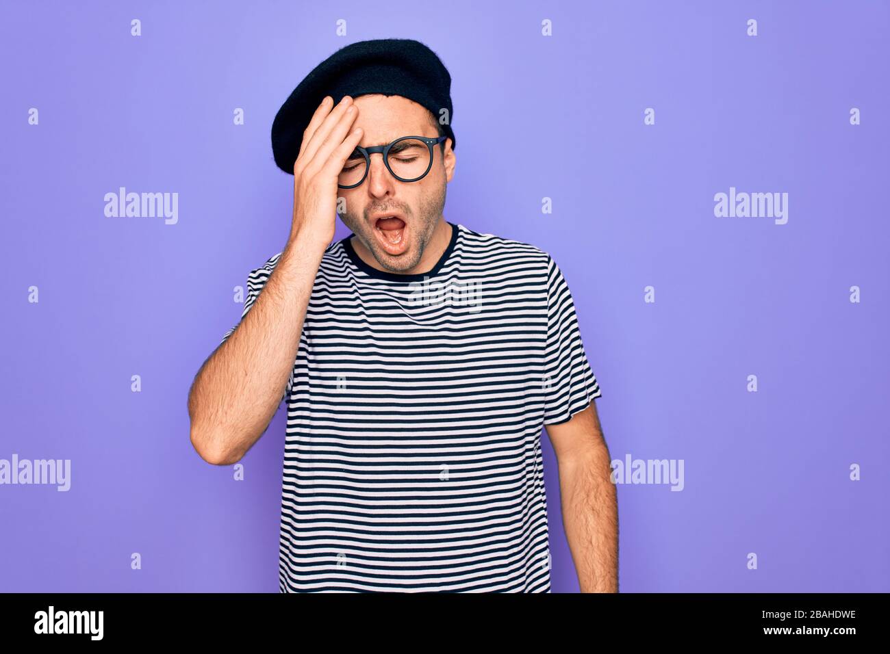 Handsome man with blue eyes wearing striped t-shirt and french beret ...
