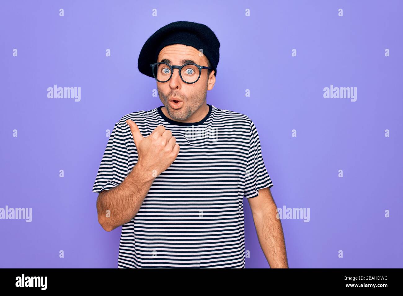 Handsome man with blue eyes wearing striped t-shirt and french beret ...
