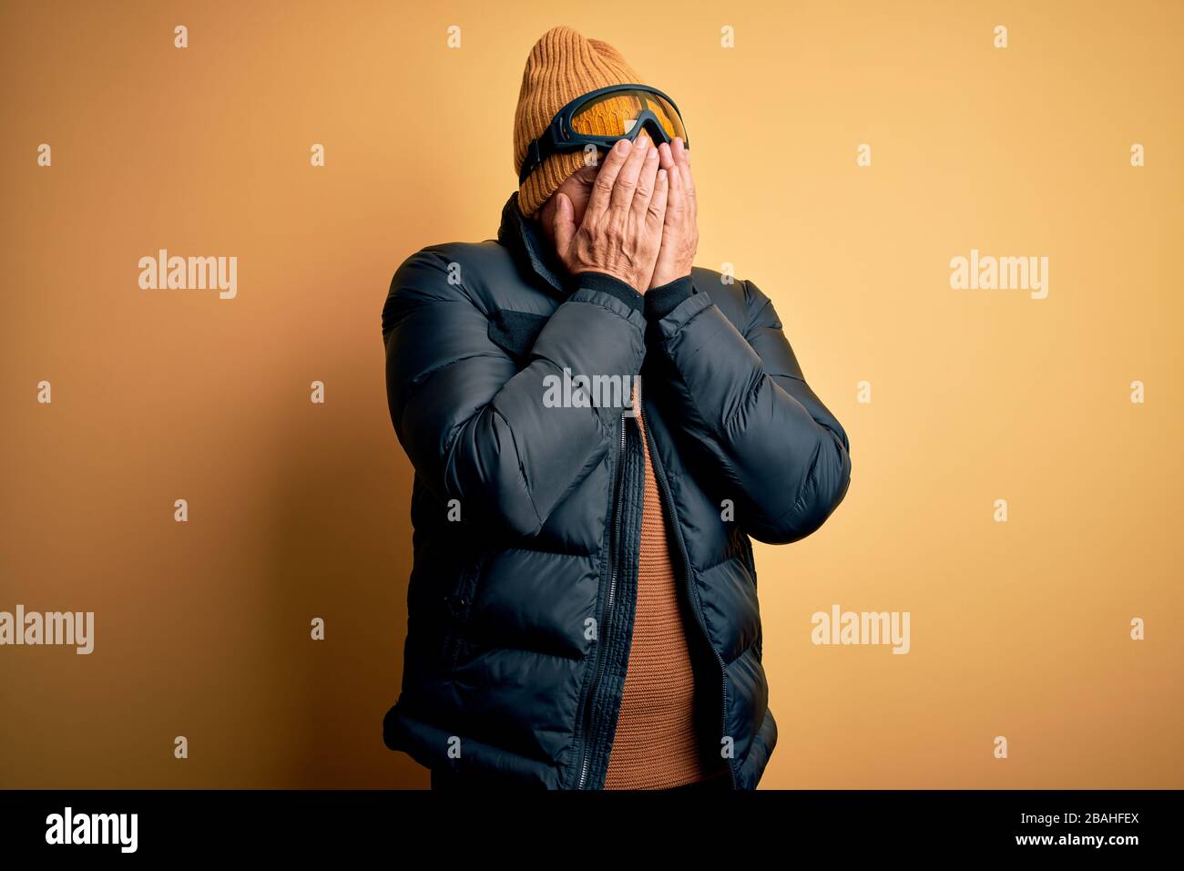 Middle age handsome grey-haired skier man on vacation wearing ski ...