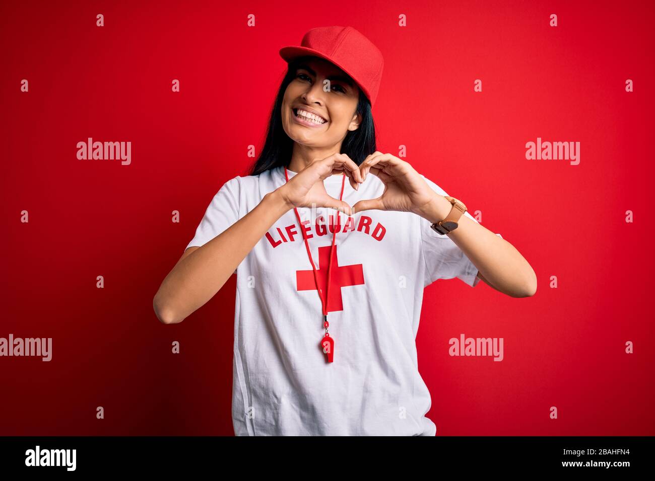 Young beautiful hispanic lifeguard woman wearing safeguard t-shirt and ...