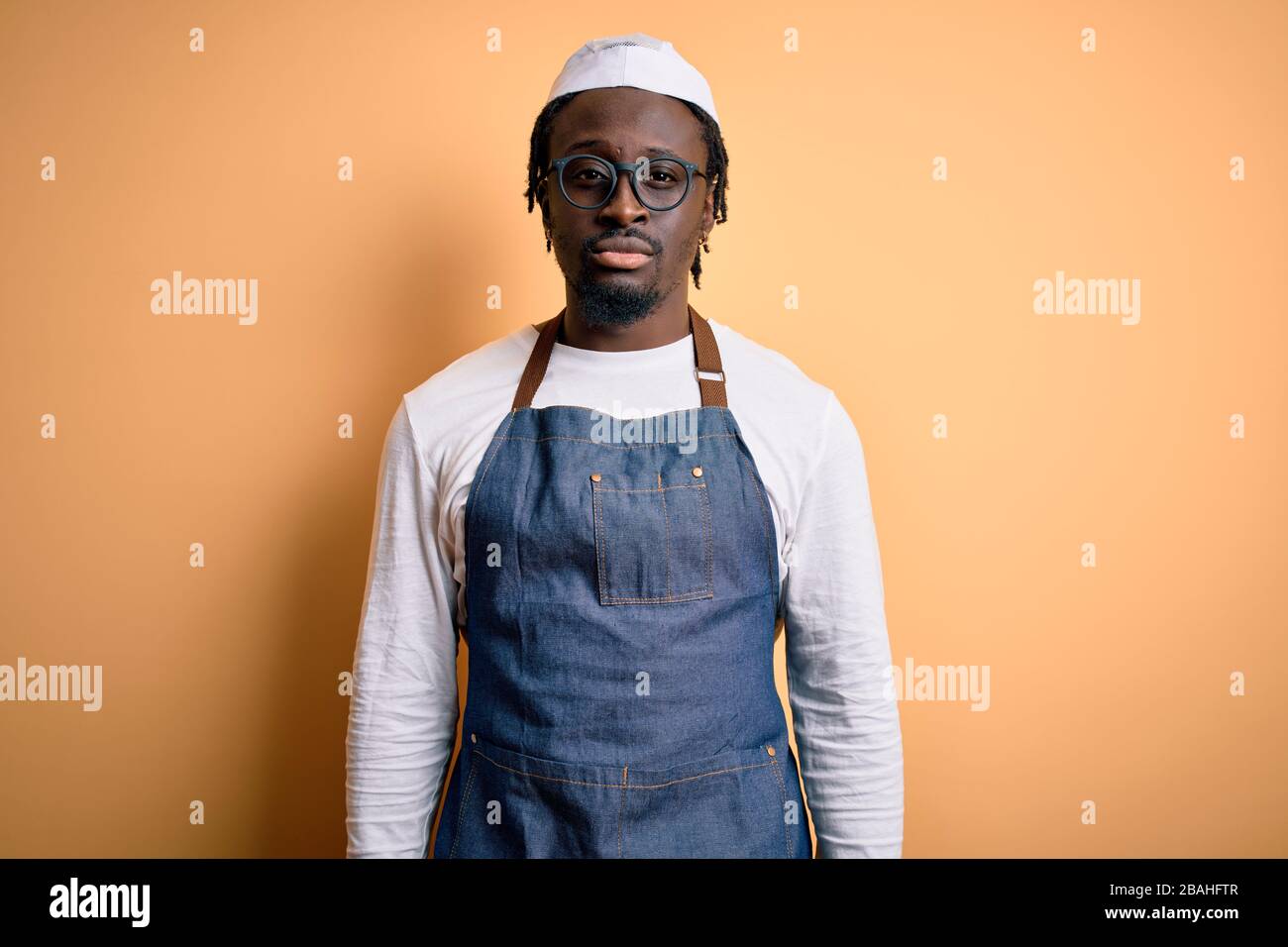 Young african american cooker man wearing apron and over isolated ...