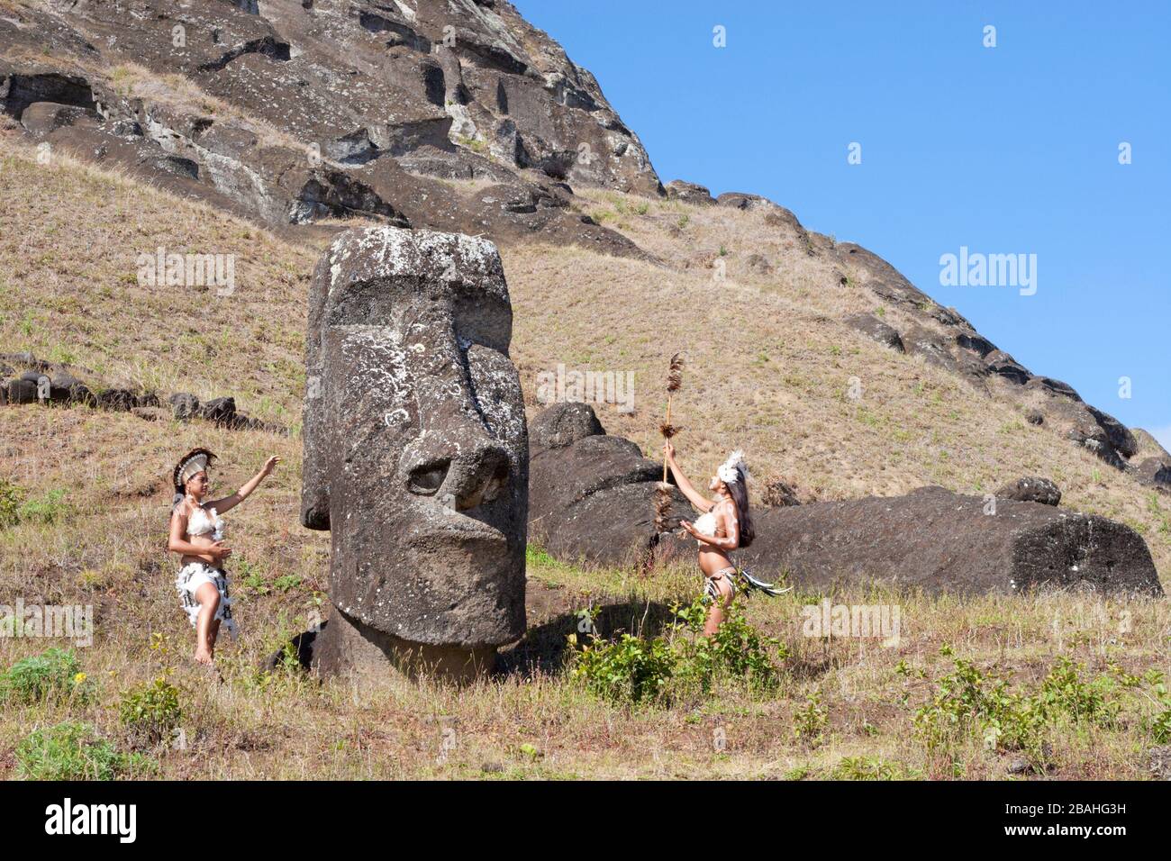 Rapa Nui dancers in traditional costume paying tribute to old giant ...