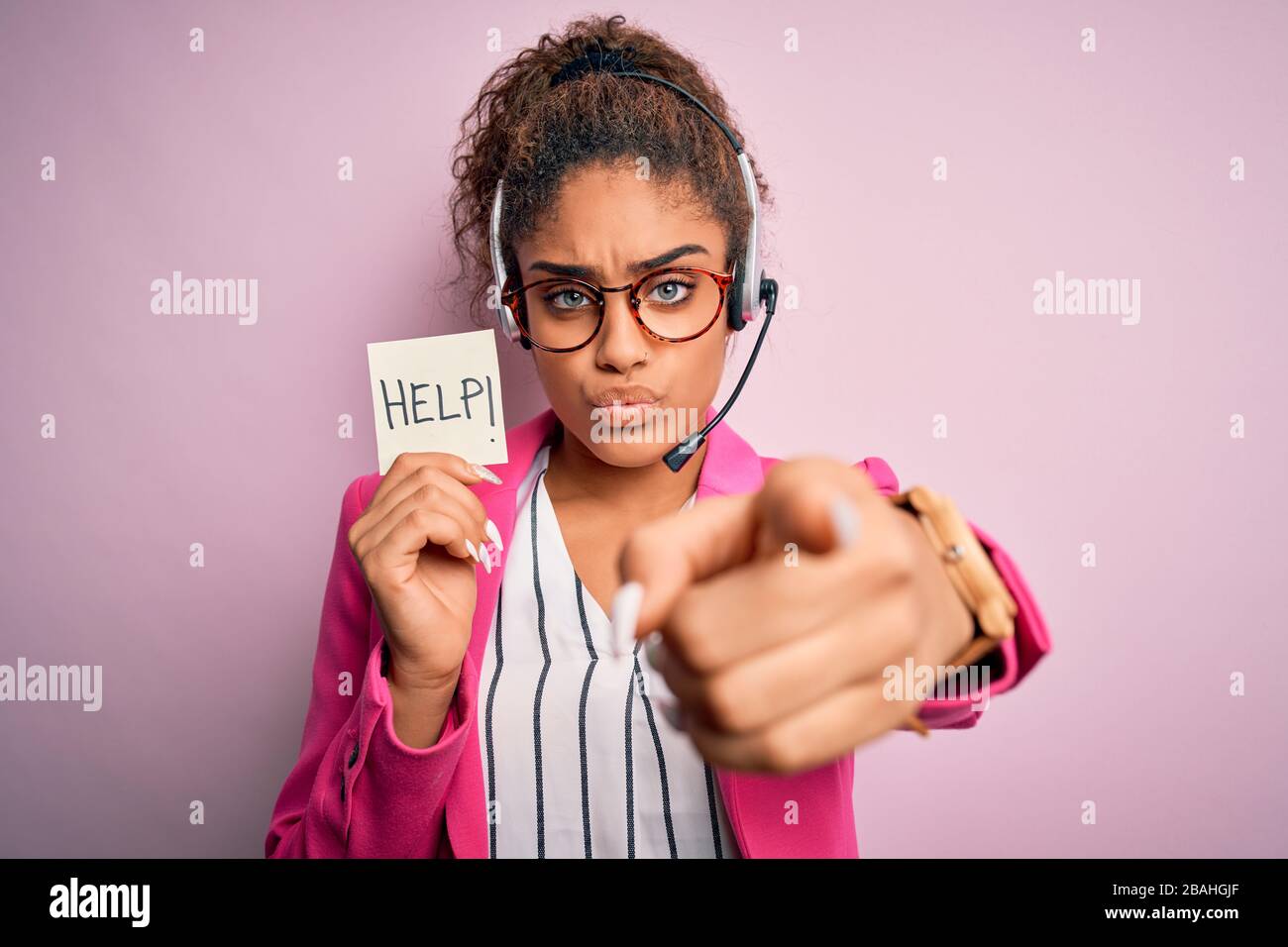 African american call center agent girl using headset holding reminder with help message ...