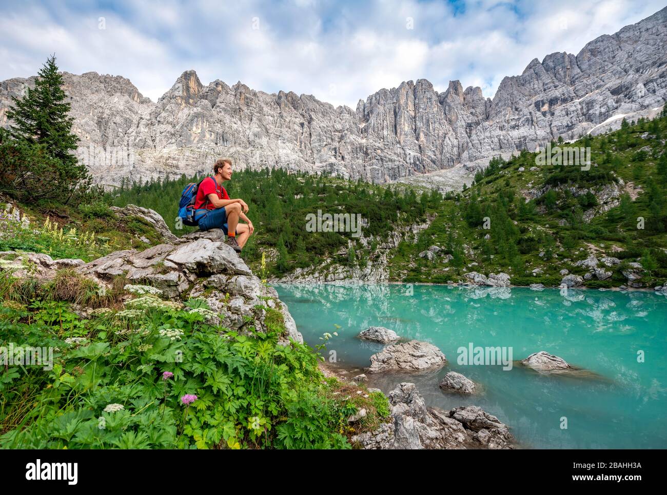 Person sitting on rock hi-res stock photography and images - Alamy