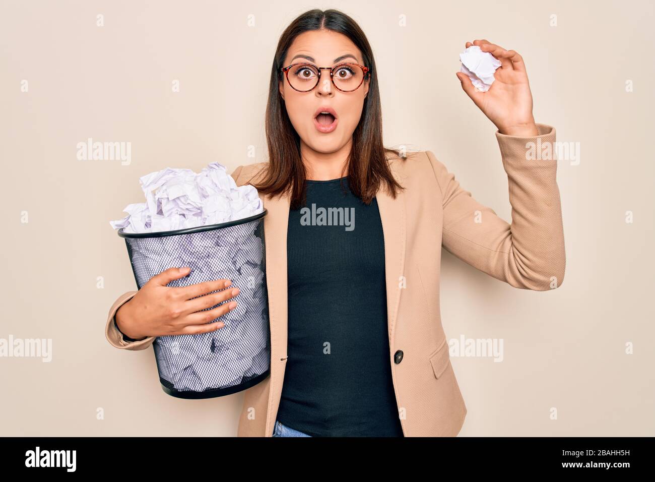 Young beautiful brunette business woman holding full paper bin of ...