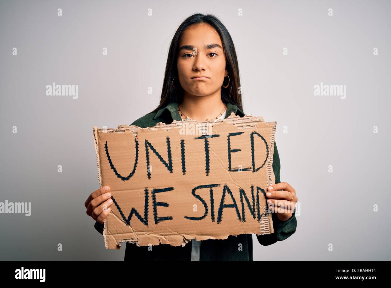 Young beautiful activist asian woman asking unity holding banner with ...