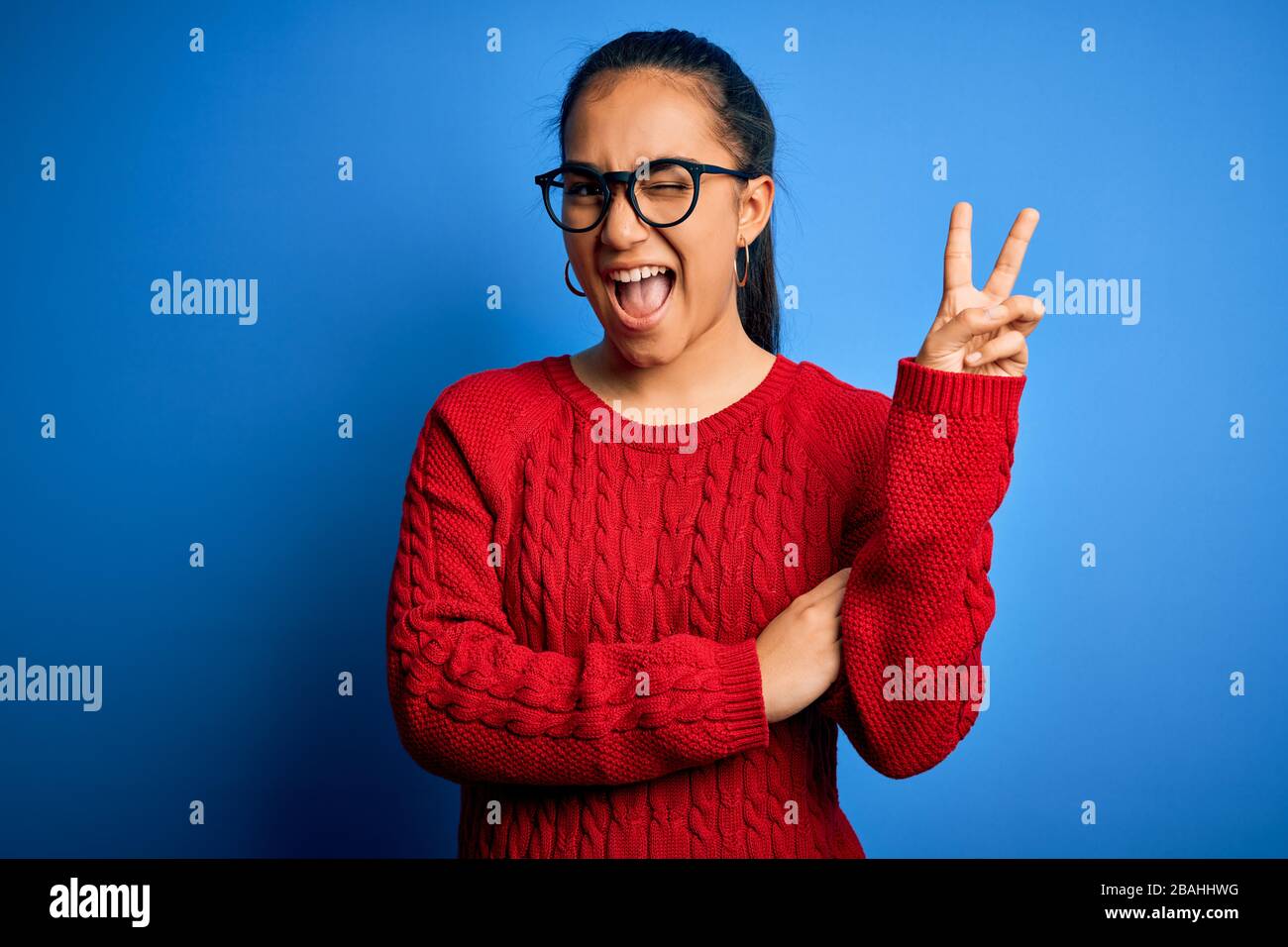 Young beautiful asian woman wearing casual sweater and glasses over ...