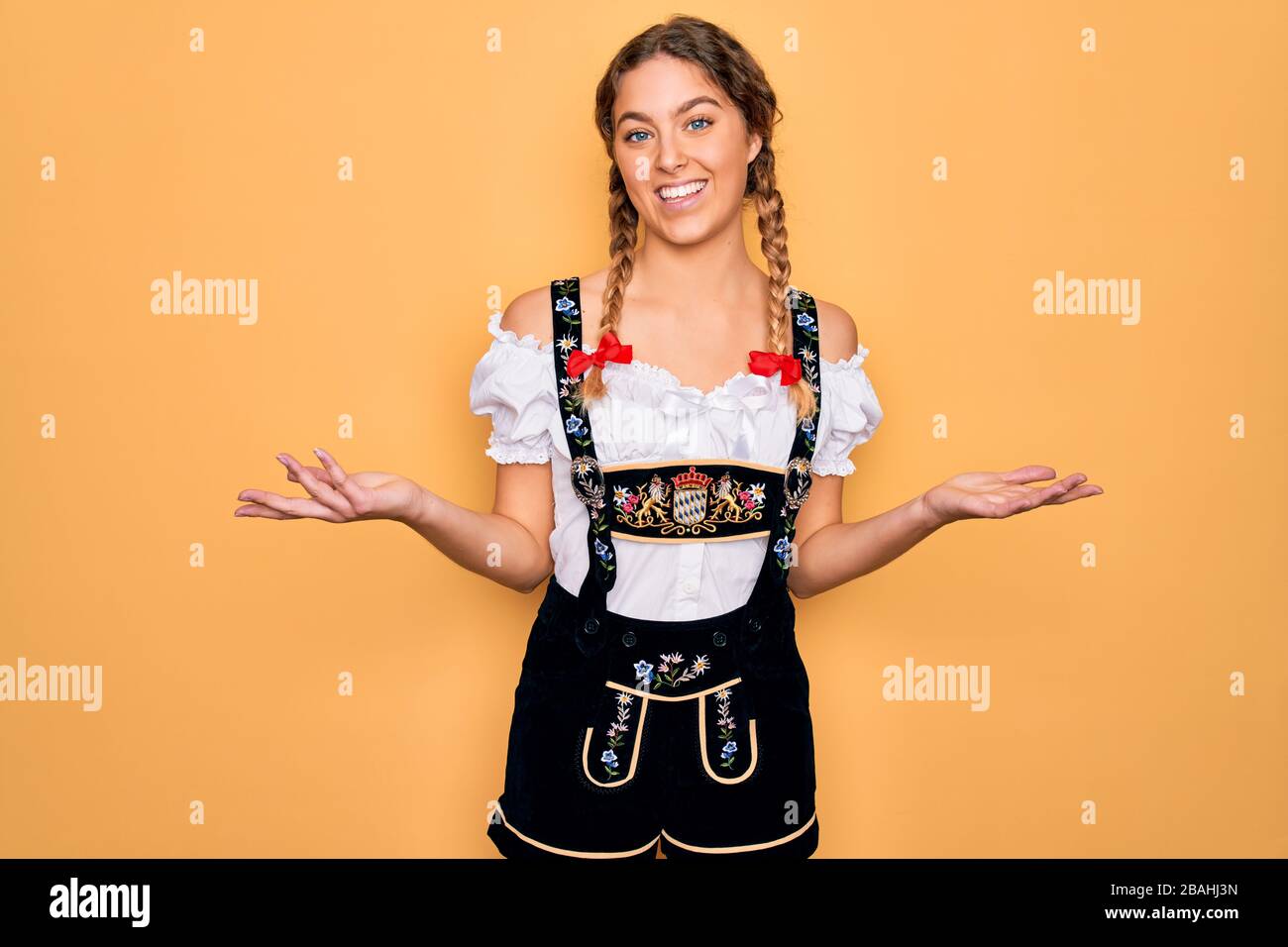 Young beautiful blonde german woman with blue eyes wearing traditional ...