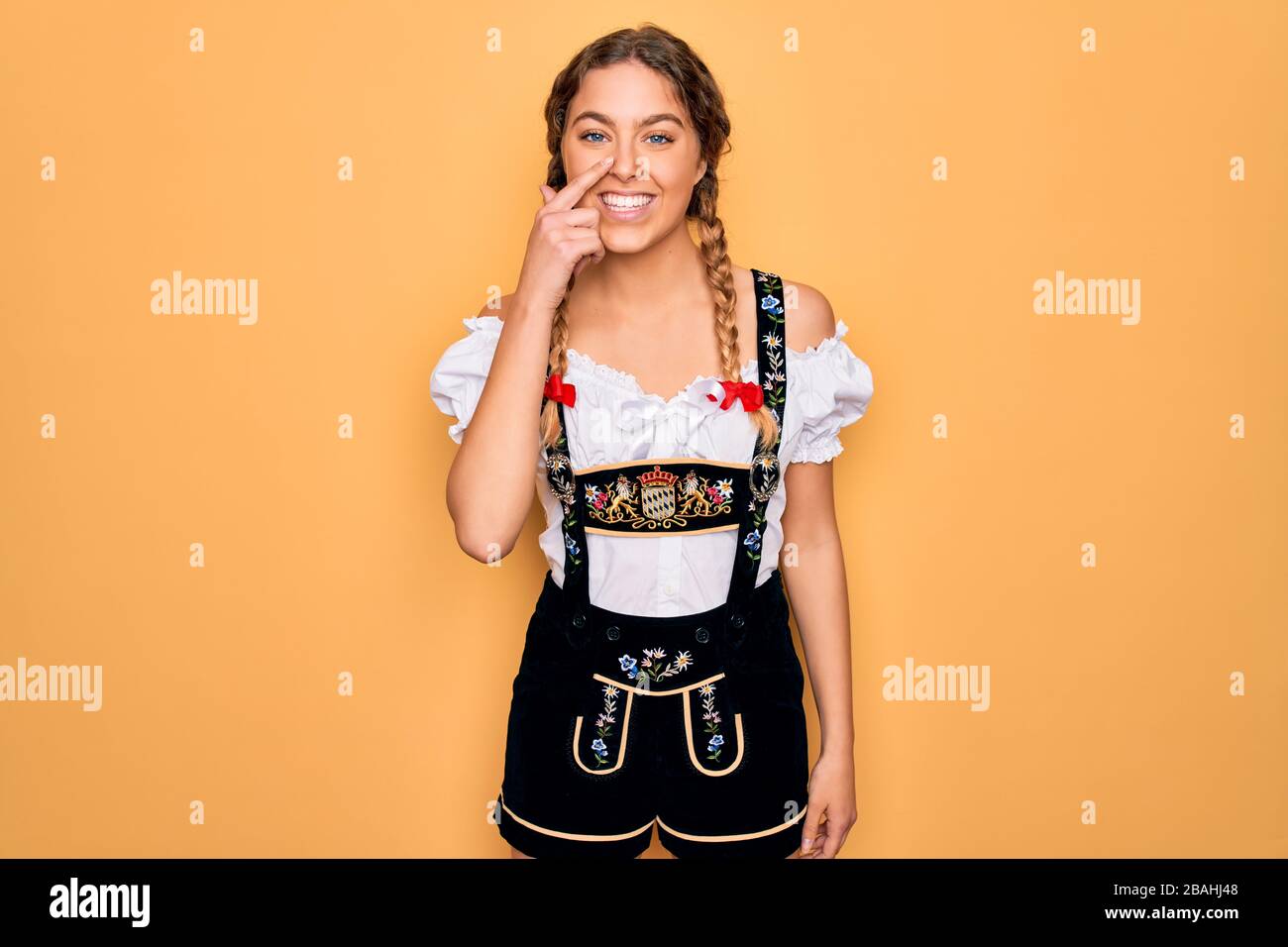 Young beautiful blonde german woman with blue eyes wearing traditional ...