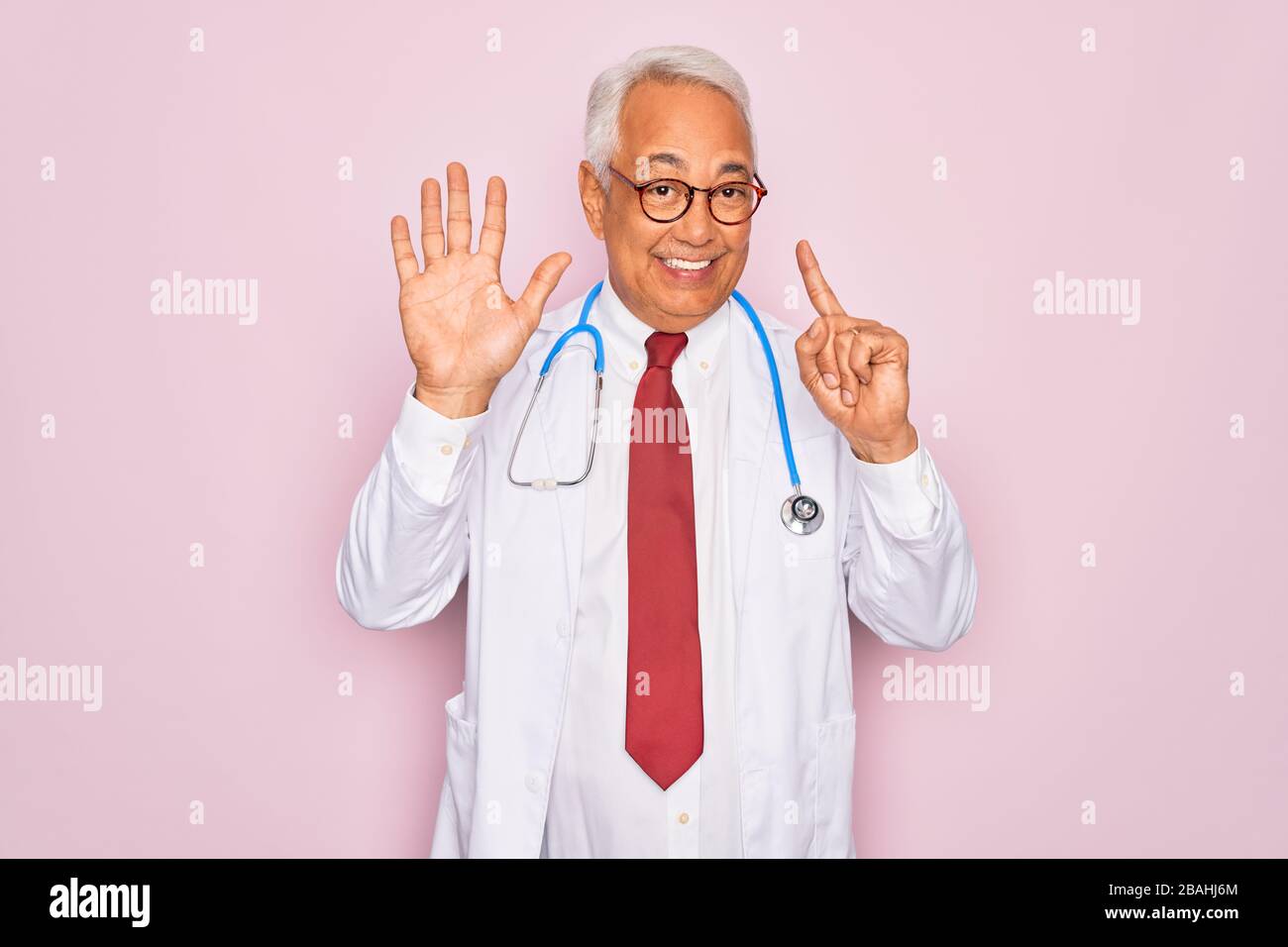 Middle age senior grey-haired doctor man wearing stethoscope and ...