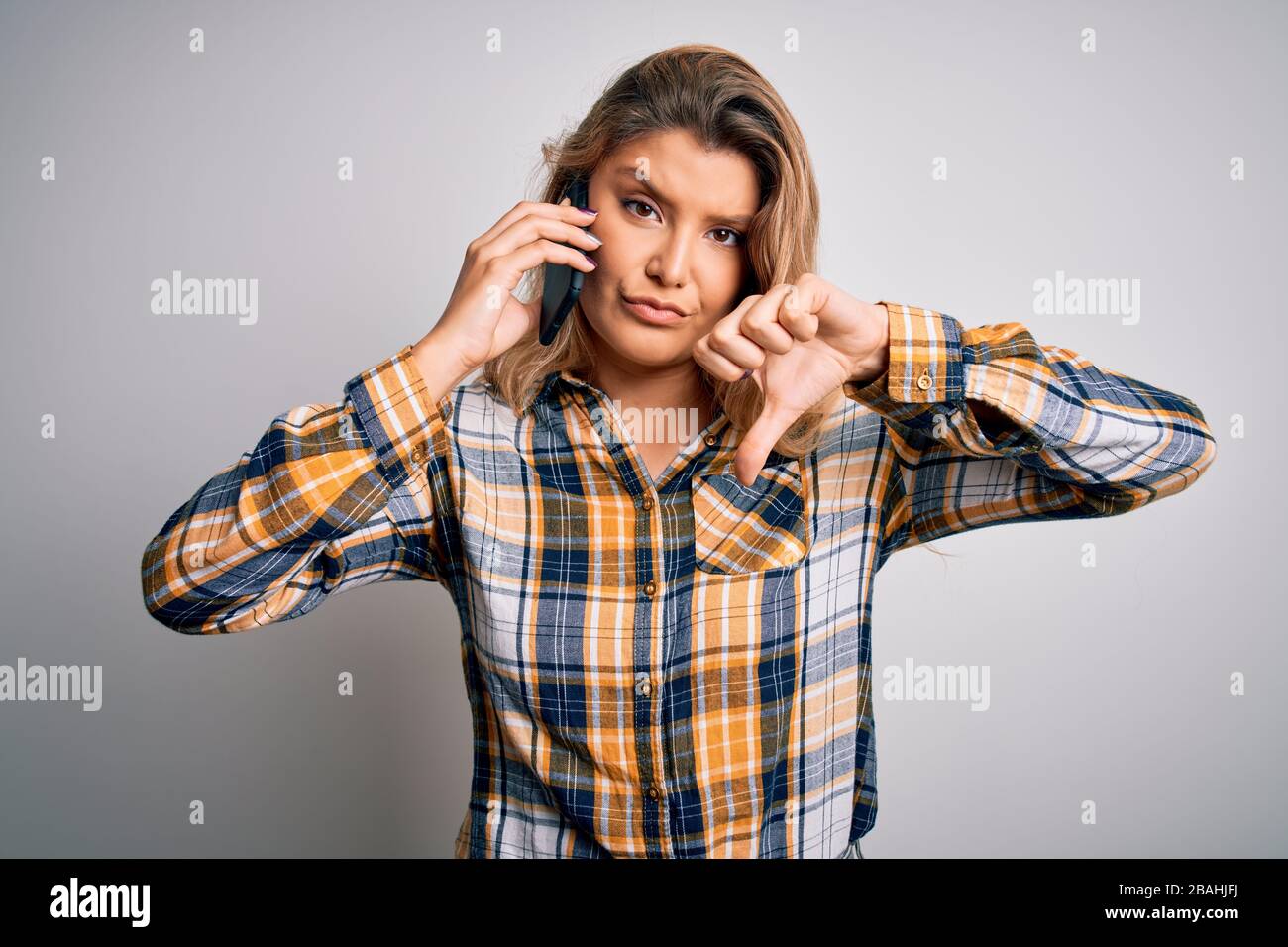 Beautiful blonde woman having conversation talking on the smartphone ...