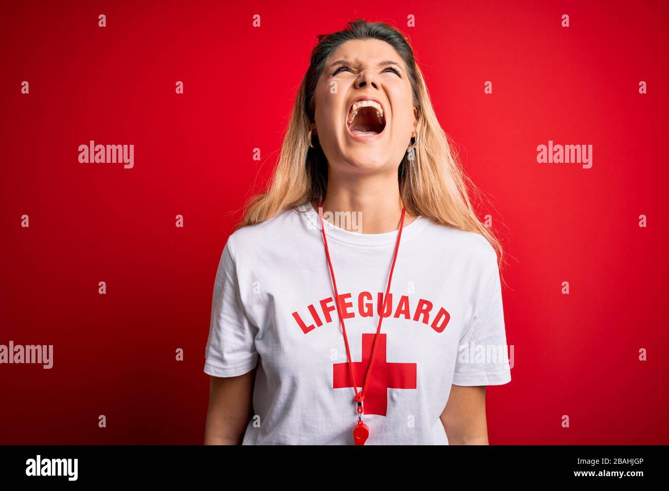 Young beautiful blonde lifeguard woman wearing t-shirt with red cross ...