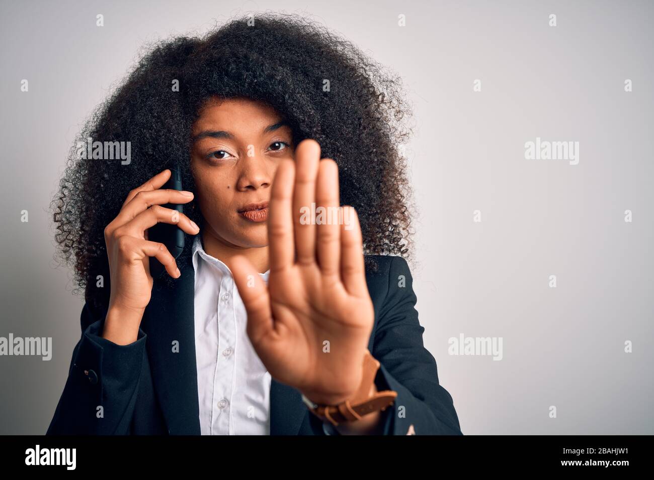 Young african american business woman with afro hair calling using ...