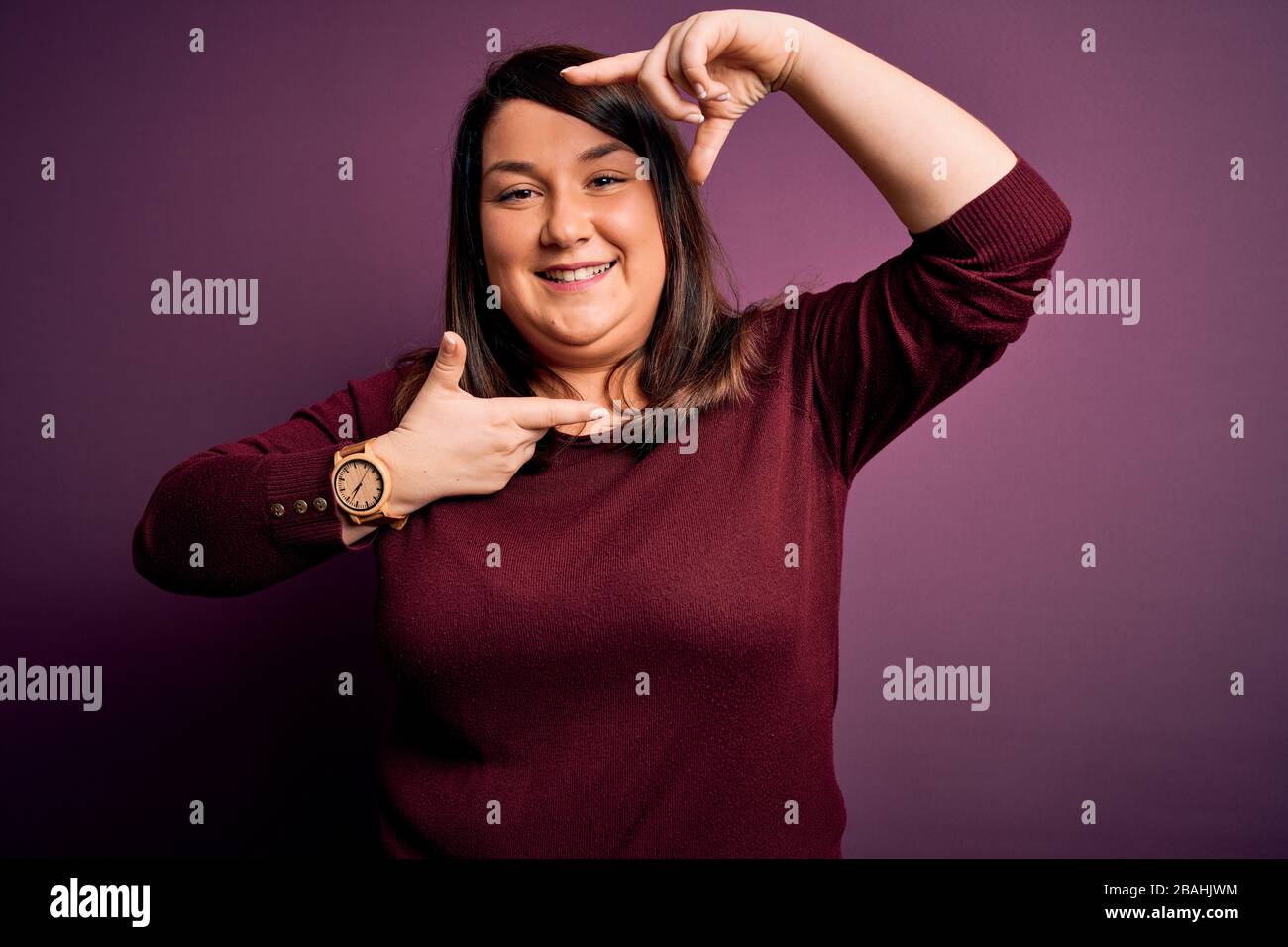 Beautiful brunette plus size woman wearing casual sweater over isolated ...