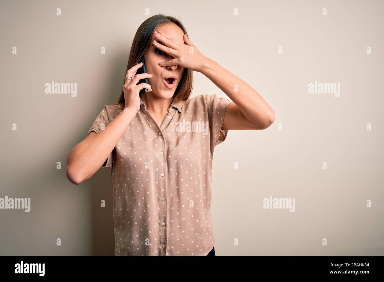 Young beautiful woman having conversation talking on the smartphone ...