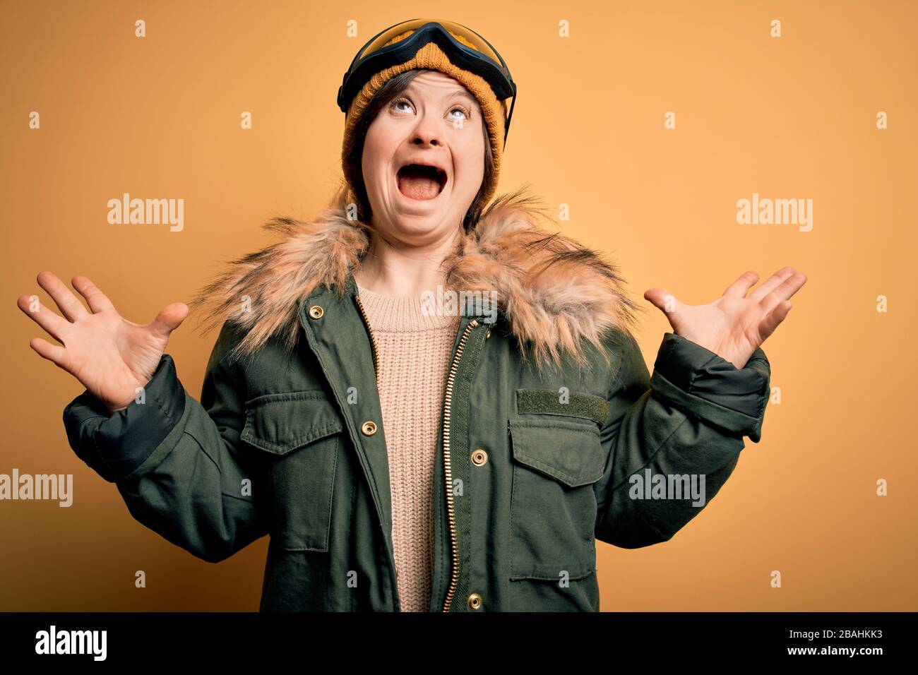 Young down syndrome woman wearing ski coat and glasses for winter ...