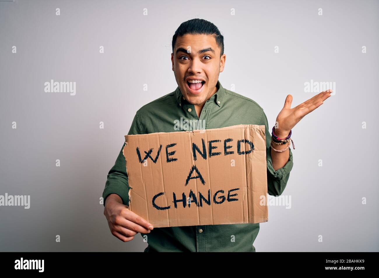 Young brazilian activist man asking for change holding banner over ...