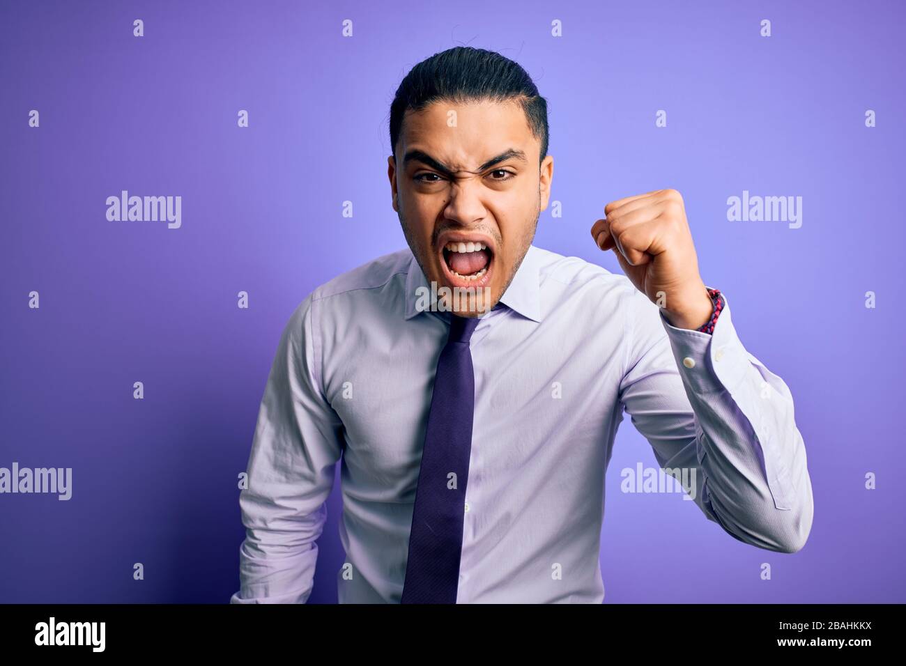 Young brazilian businessman wearing elegant tie standing over isolated ...