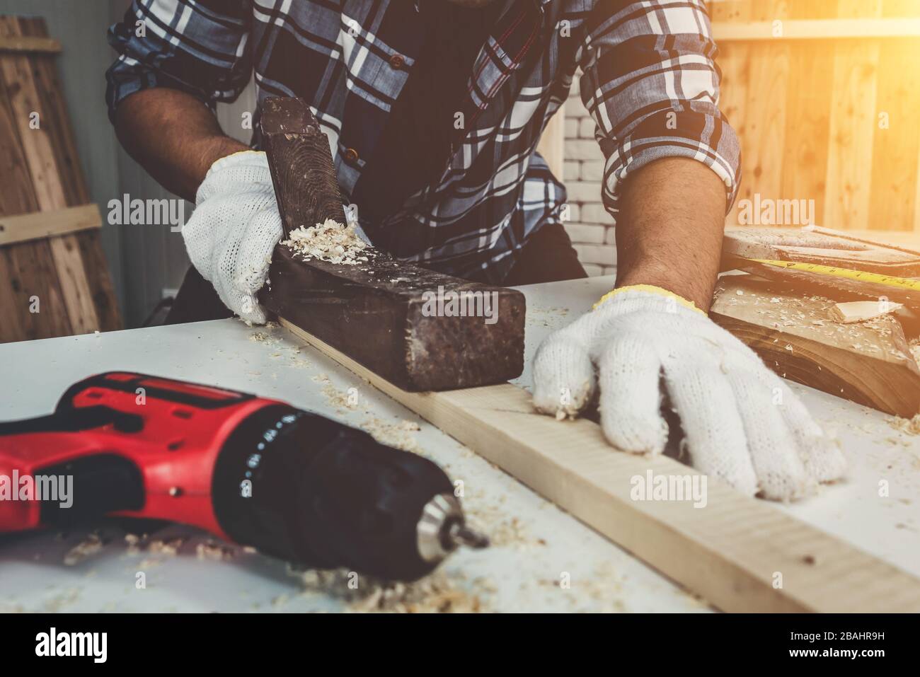 Carpenter working on wood craft at workshop to produce construction ...