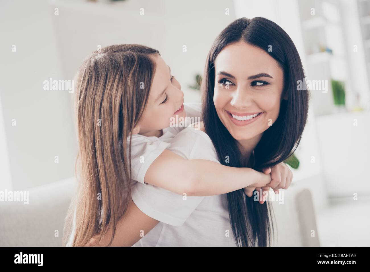 Closeup profile photo of cute small girl and young charming mom hugging ...