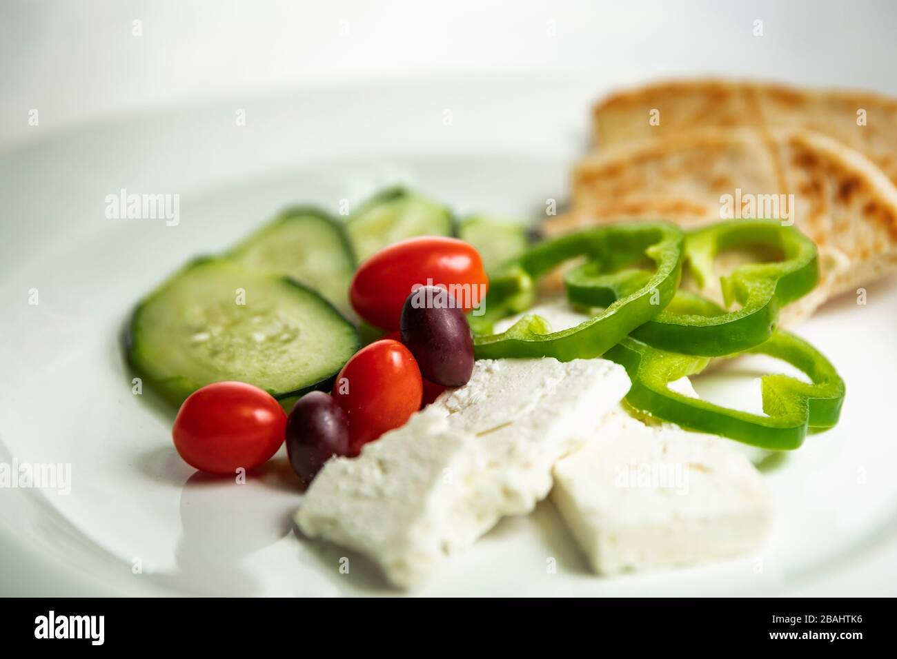 Shallow focus view of simple Greek meze food platter; with vegetables ...